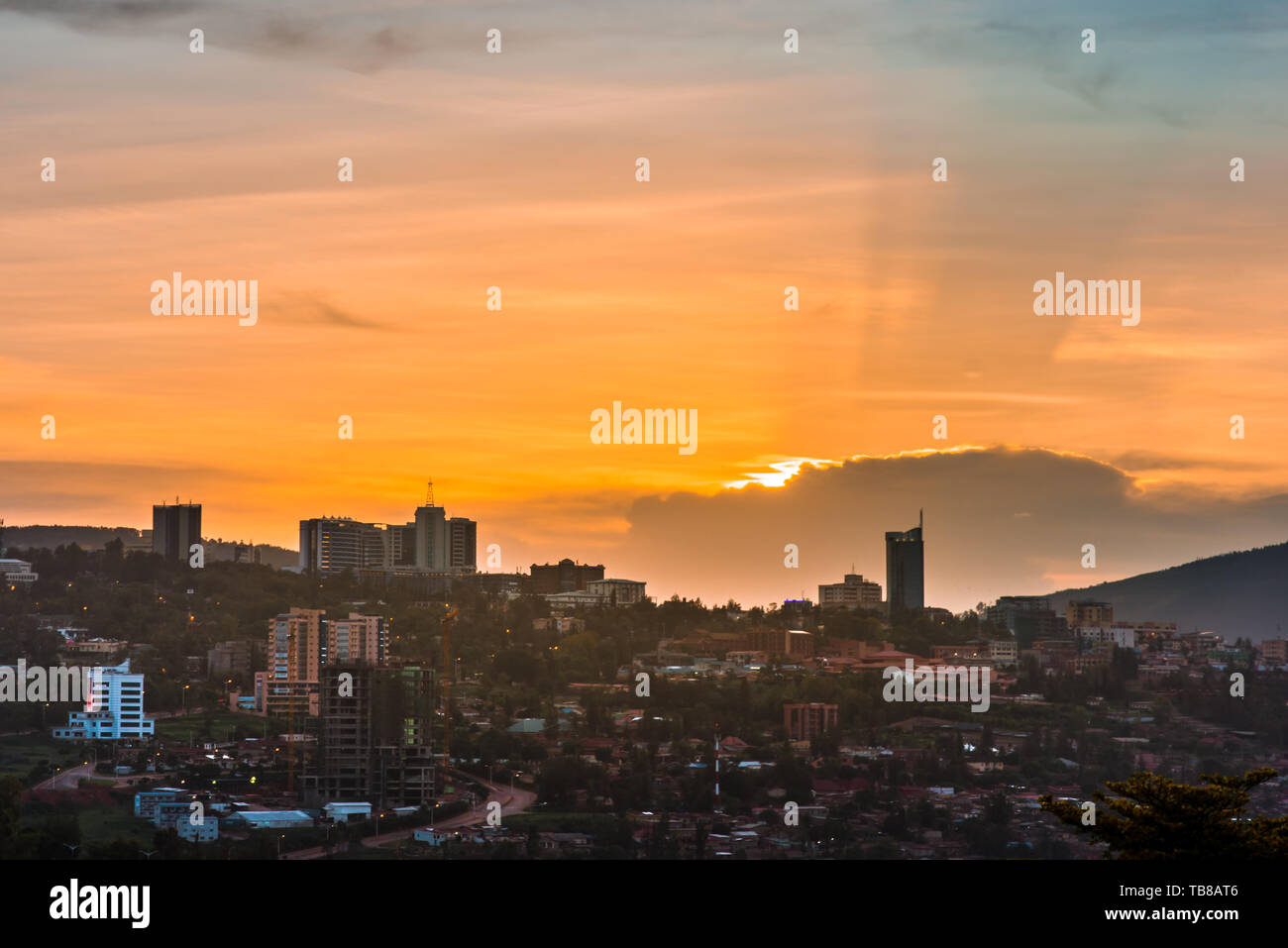 Kigali city centre skyline and surrounding areas under colorful clouds ...