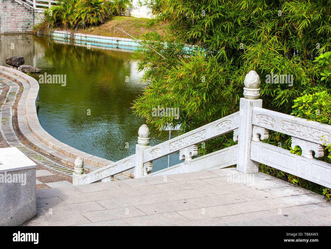 stone staircase with railing and walkway along the pond Stock Photo - Alamy