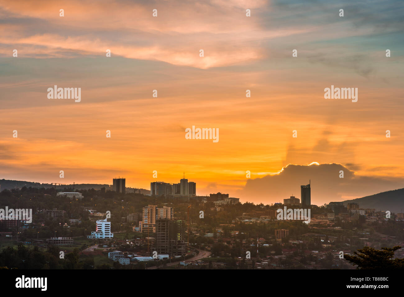 Kigali city centre skyline and surrounding areas under colorful clouds ...
