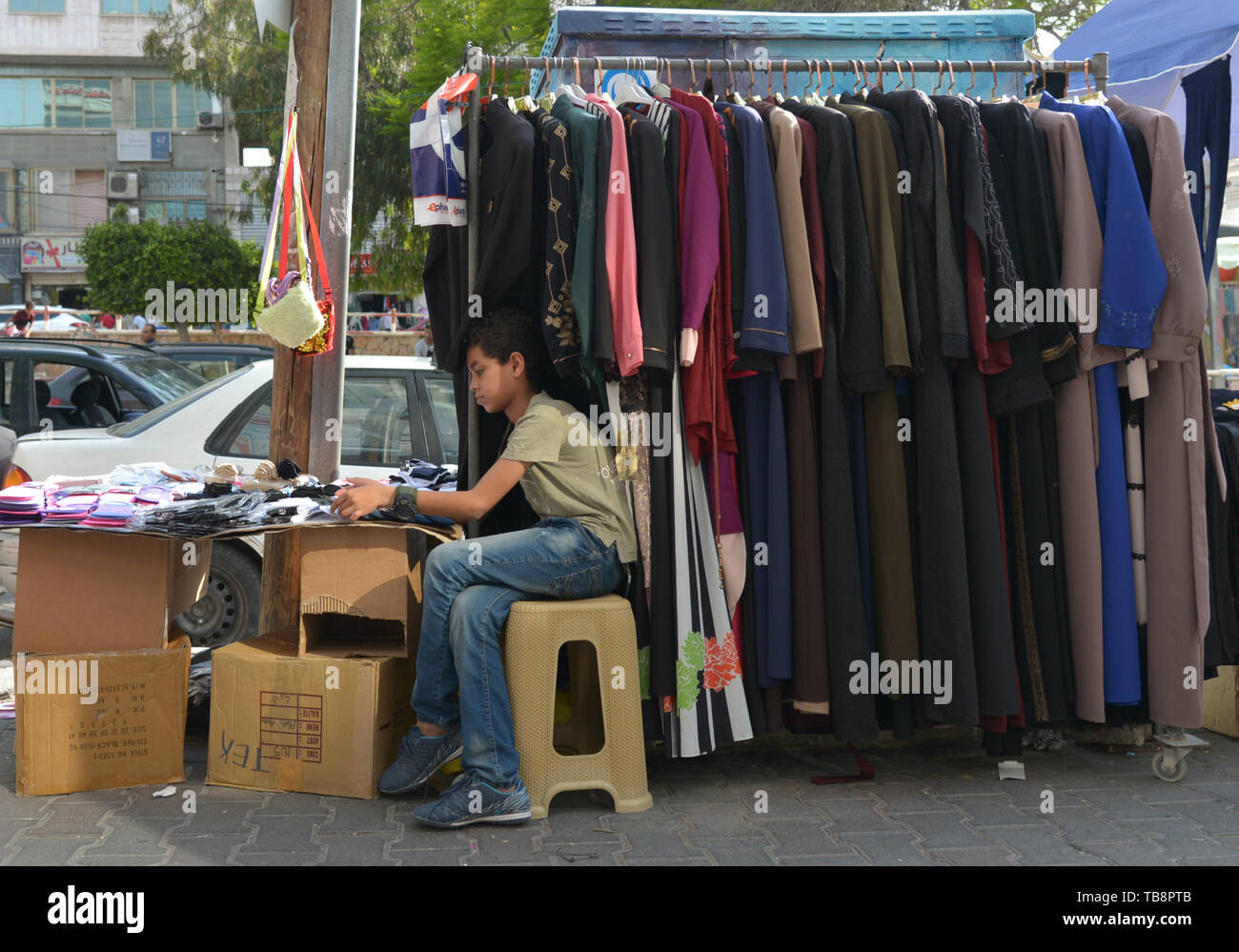 Gaza. 30th May, 2019. A Palestinian vendor sells clothes at a market ...