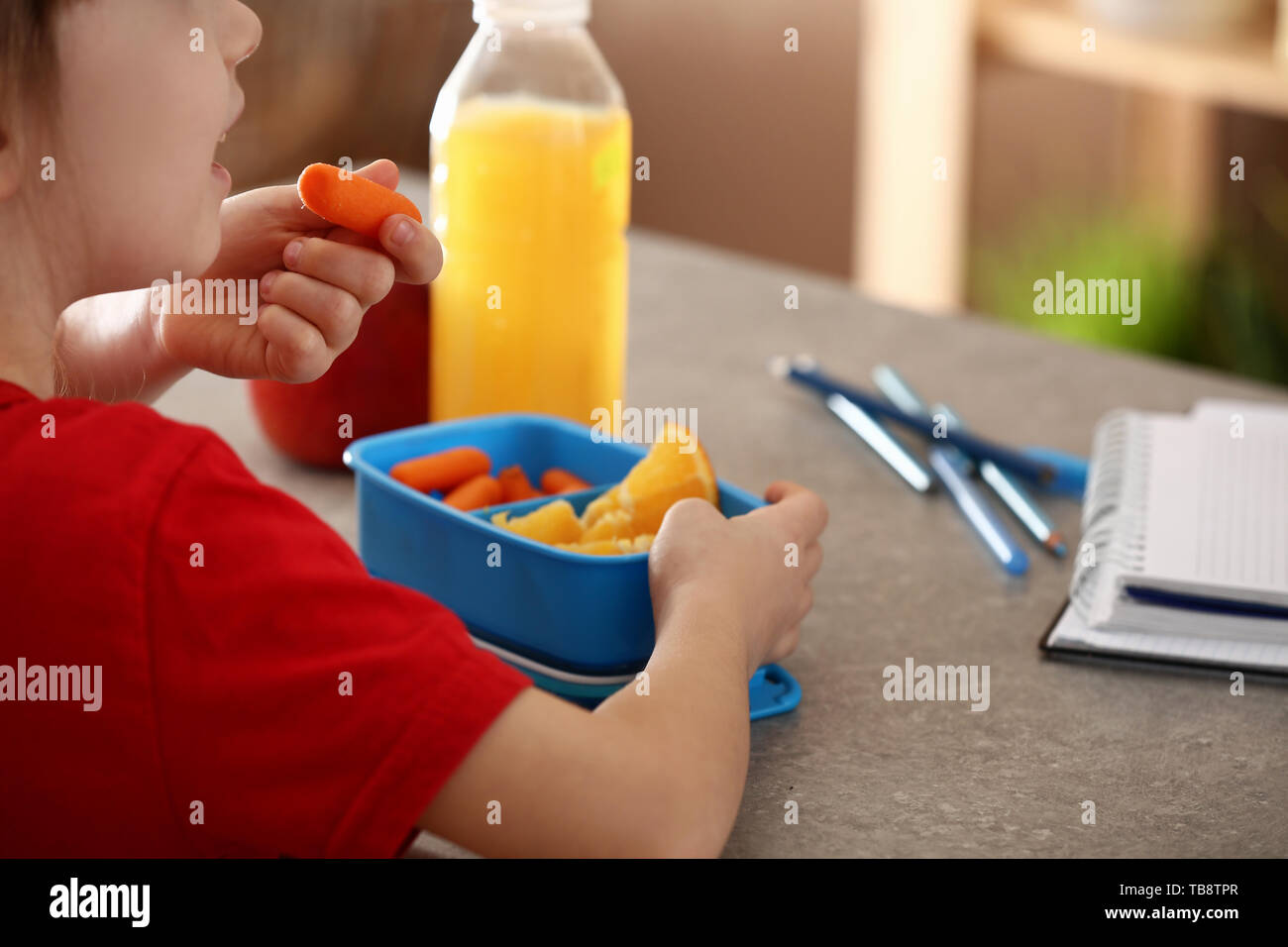 Little girl having school lunch in classroom Stock Photo - Alamy