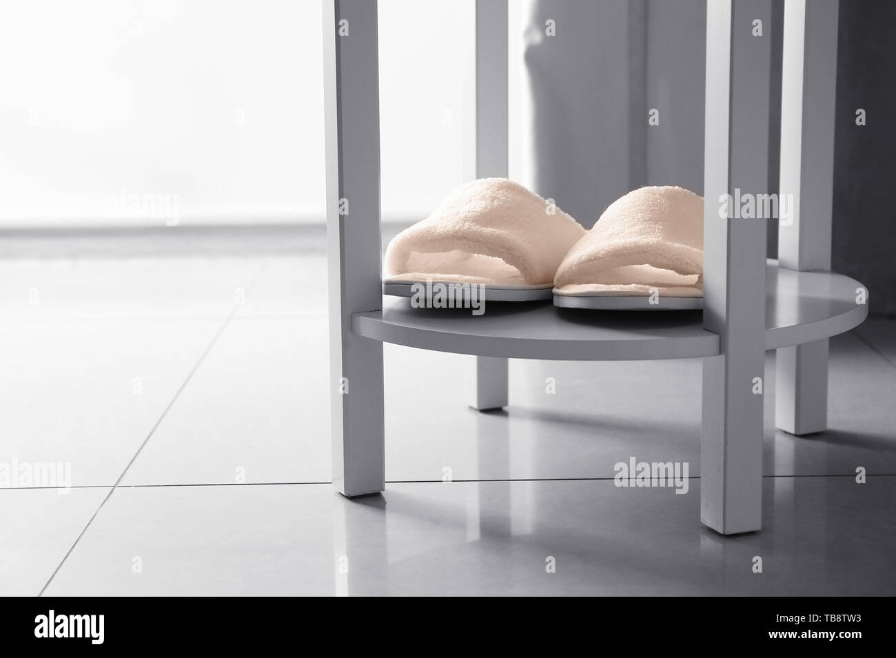 Soft slippers on shelf in room Stock Photo - Alamy