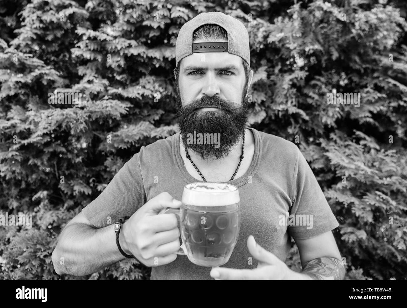 Drinking like a hipster. Hipster drinker holding beer mug. Bearded ...