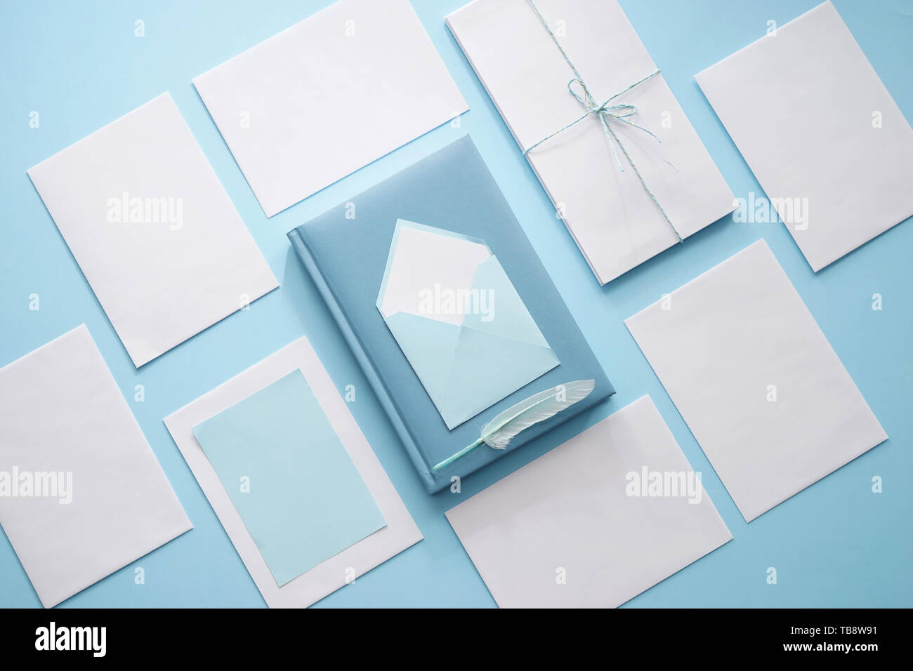 Paper envelopes and book on color background Stock Photo - Alamy