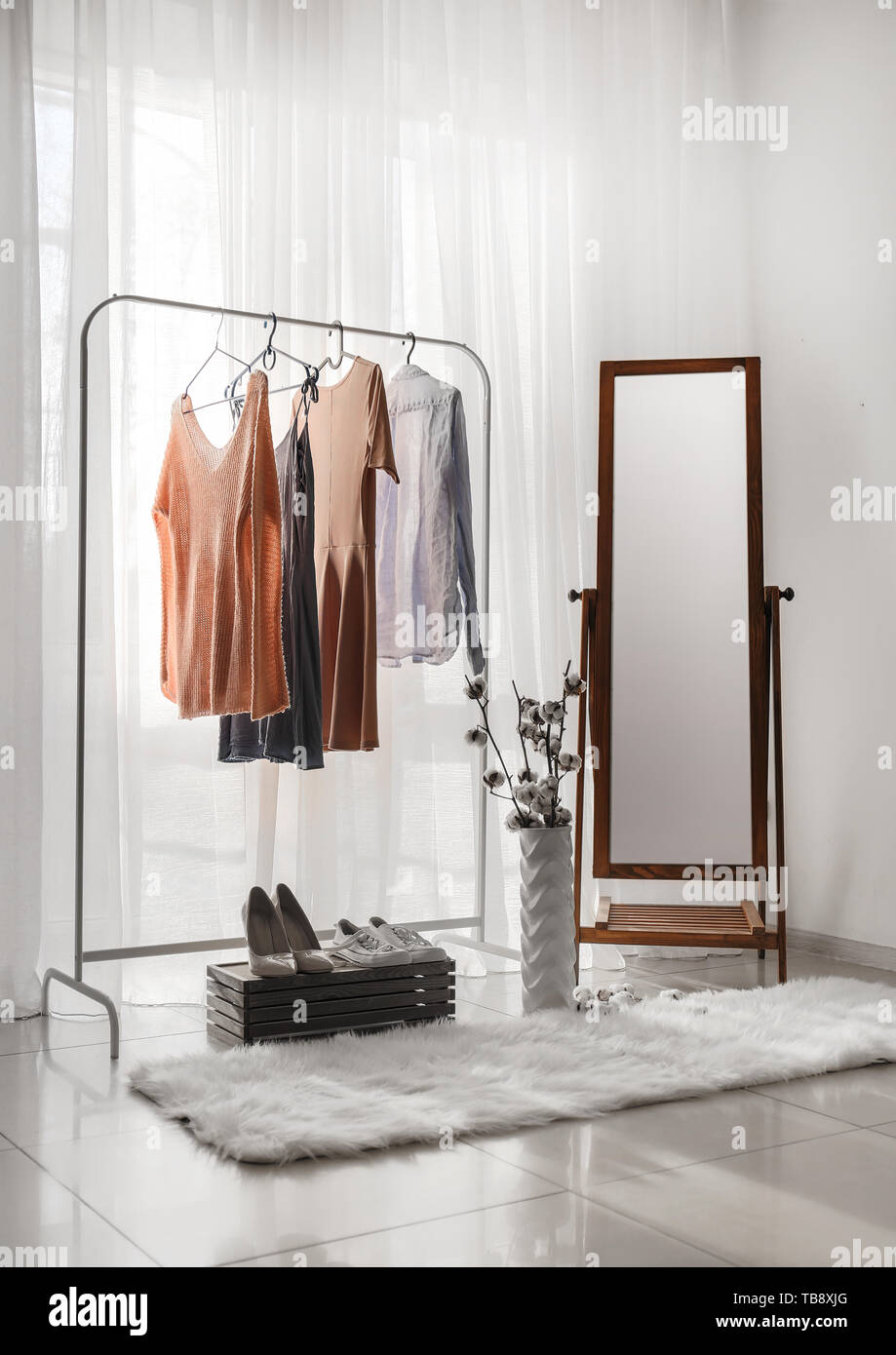 Big mirror with female clothes in interior of room Stock Photo - Alamy