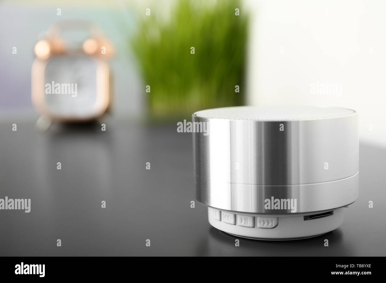 Smart home assistant device on table in room Stock Photo - Alamy