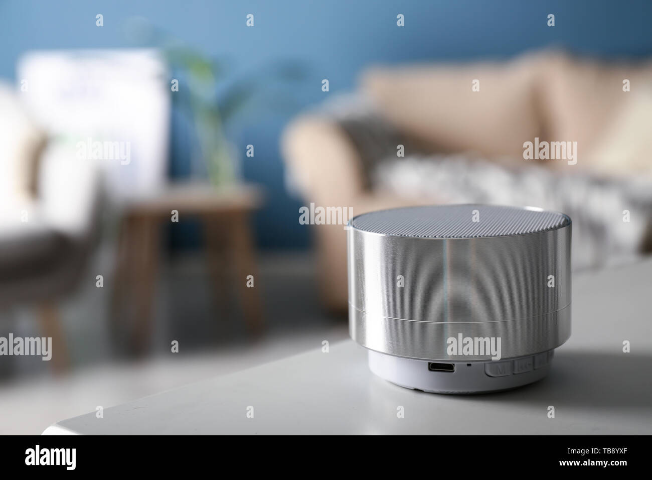 Smart home assistant device on table in room Stock Photo - Alamy