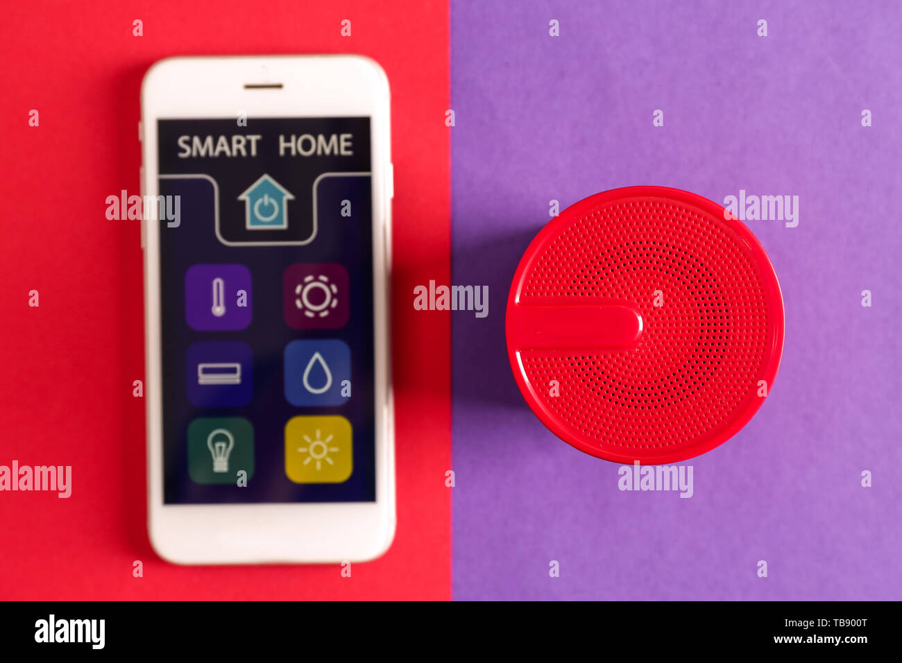 Smart home assistant device with mobile phone on color background Stock ...