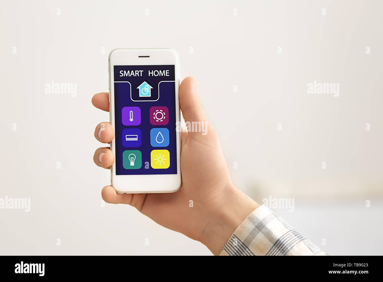 Teenage boy using application of smart home automation Stock Photo - Alamy