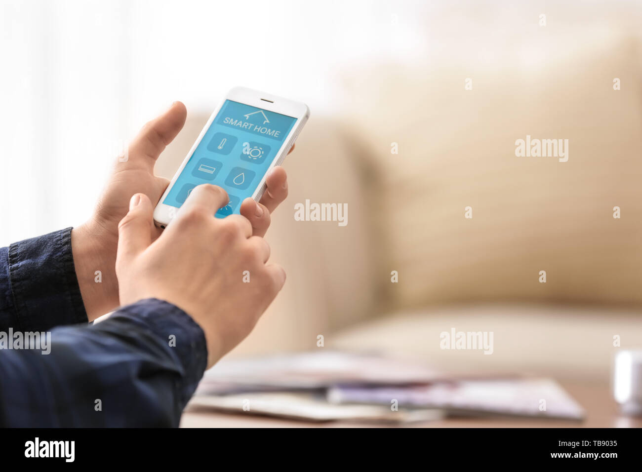 Teenage boy using application of smart home automation Stock Photo - Alamy