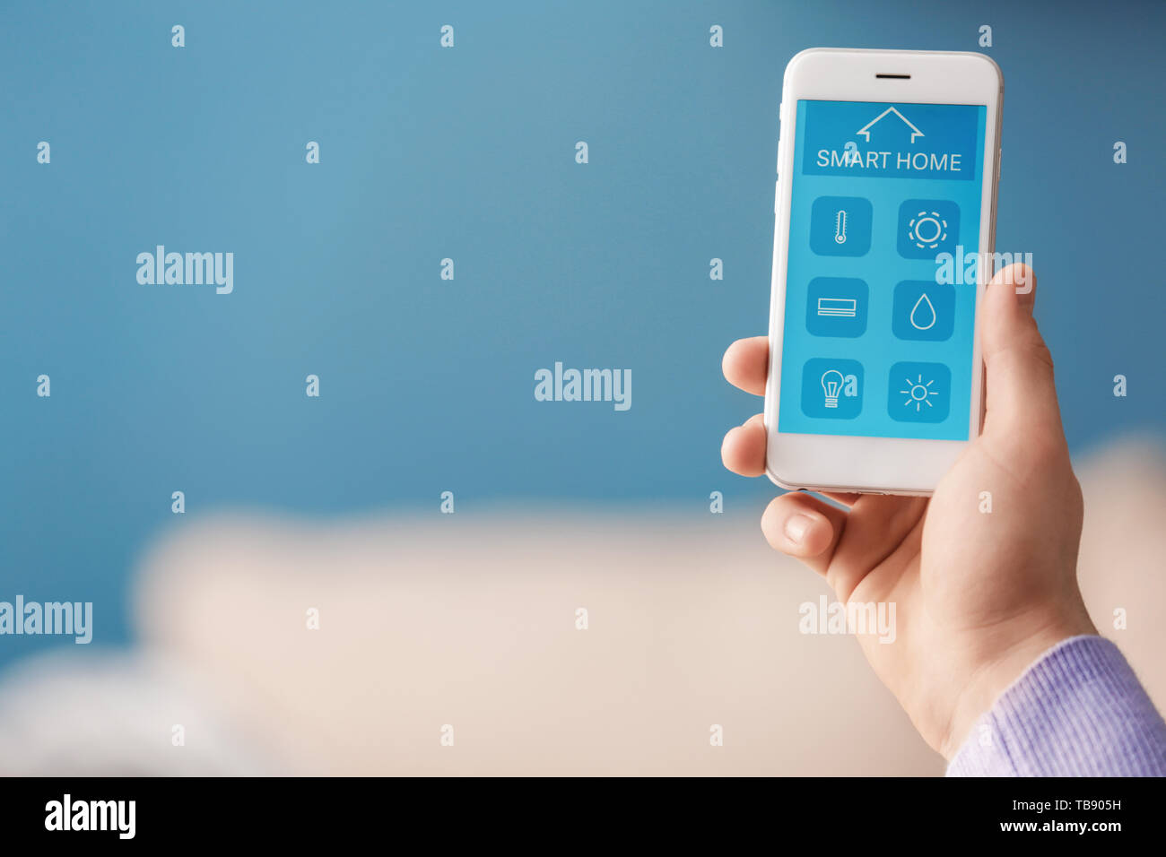 Teenage boy using application of smart home automation Stock Photo - Alamy