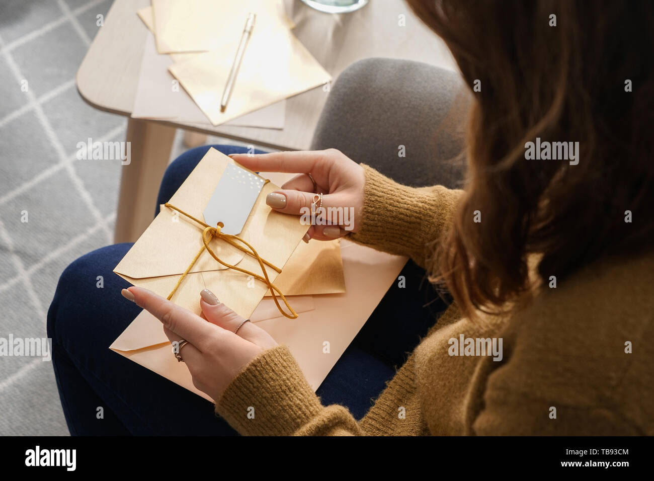 Young woman with received letters at home Stock Photo - Alamy