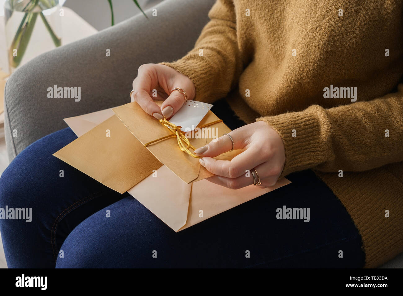 Young woman with received letters at home Stock Photo - Alamy