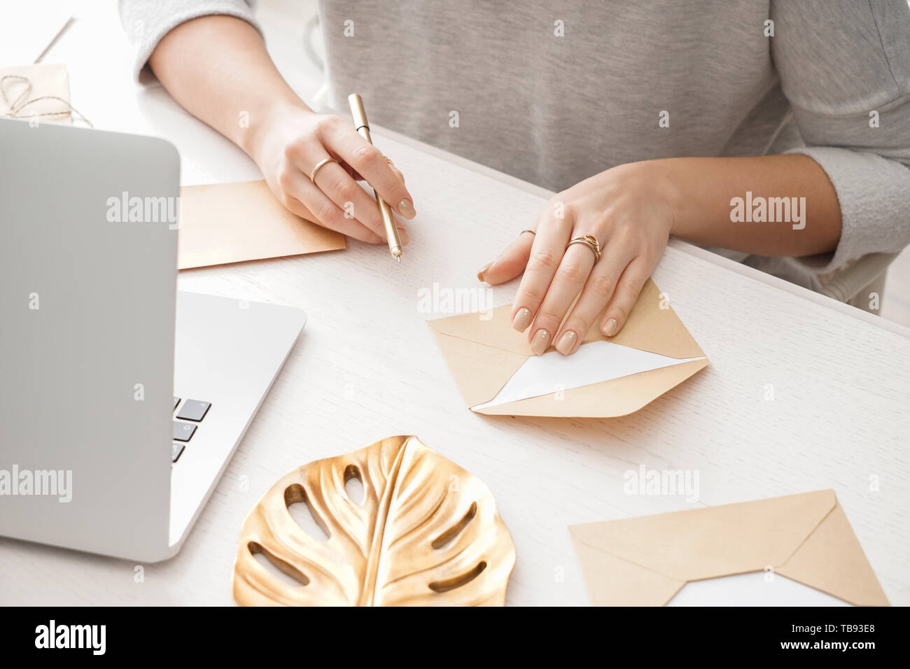 Young woman writing letter at table Stock Photo - Alamy