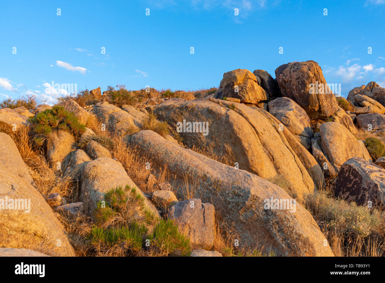 Large boulders on a hill during sunset lighting Stock Photo - Alamy