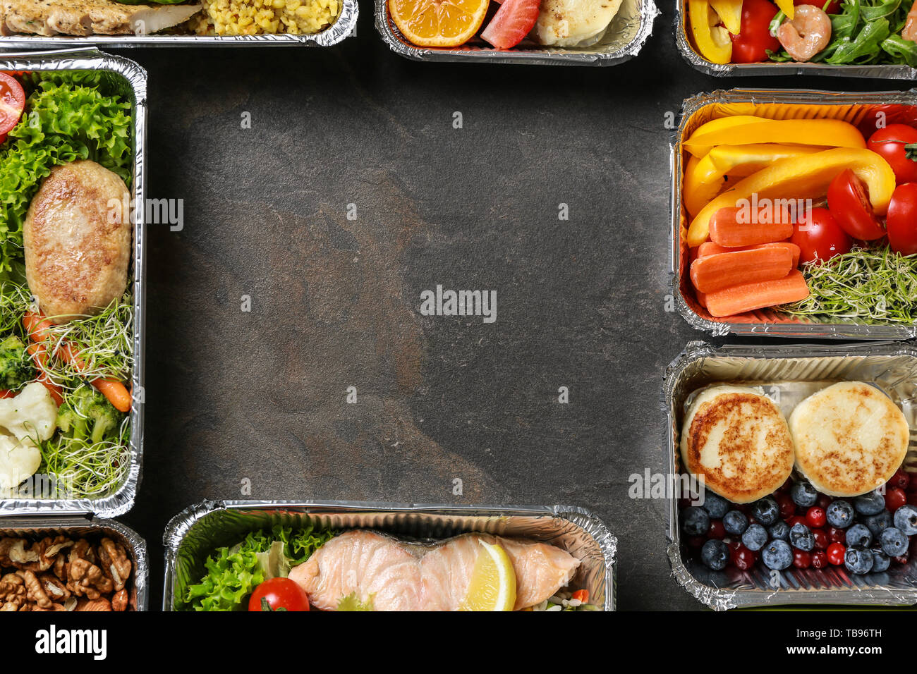 Frame made of containers with delicious food on grey background Stock ...