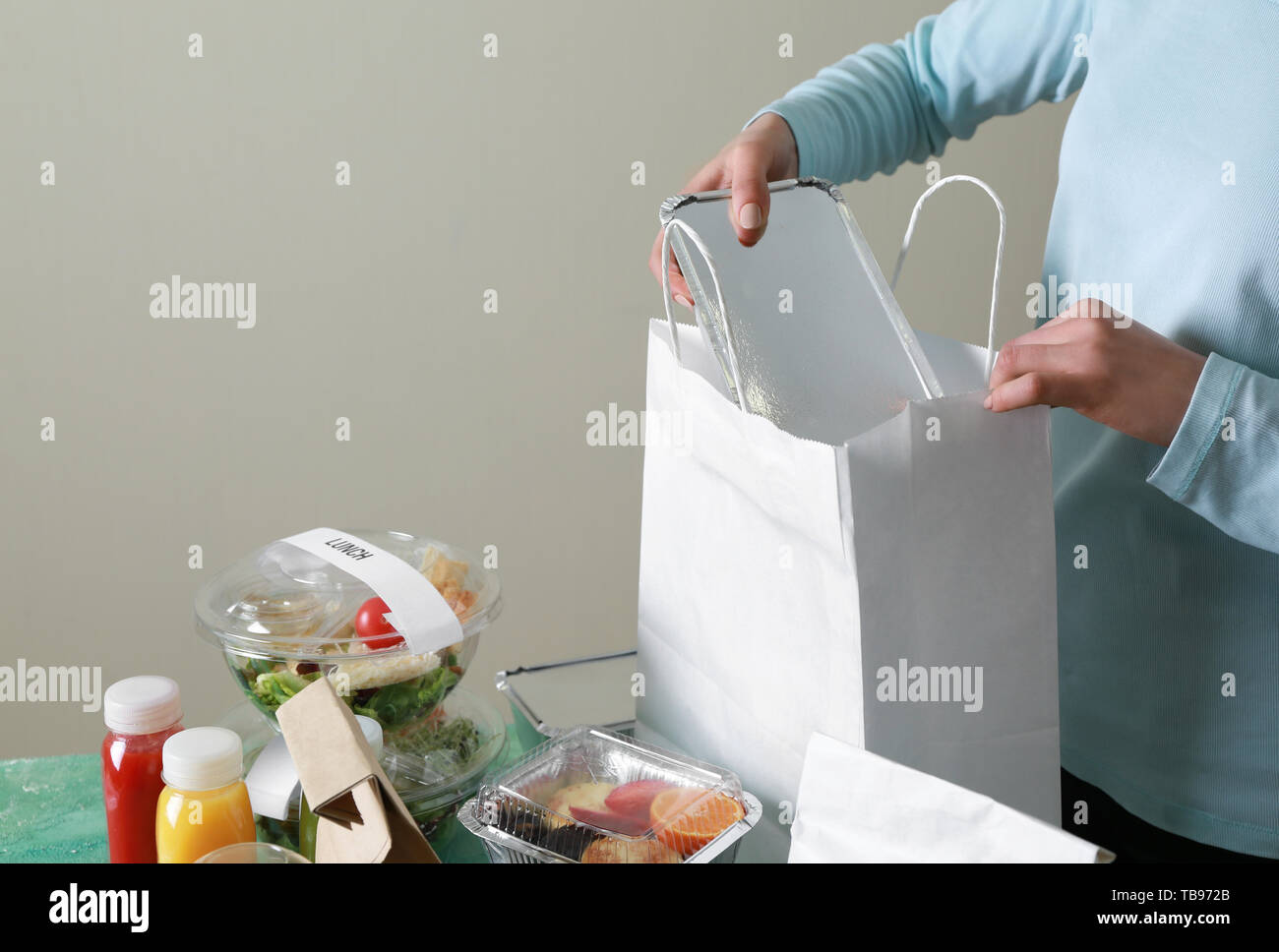 Worker of food delivery service packing order for customer Stock Photo ...