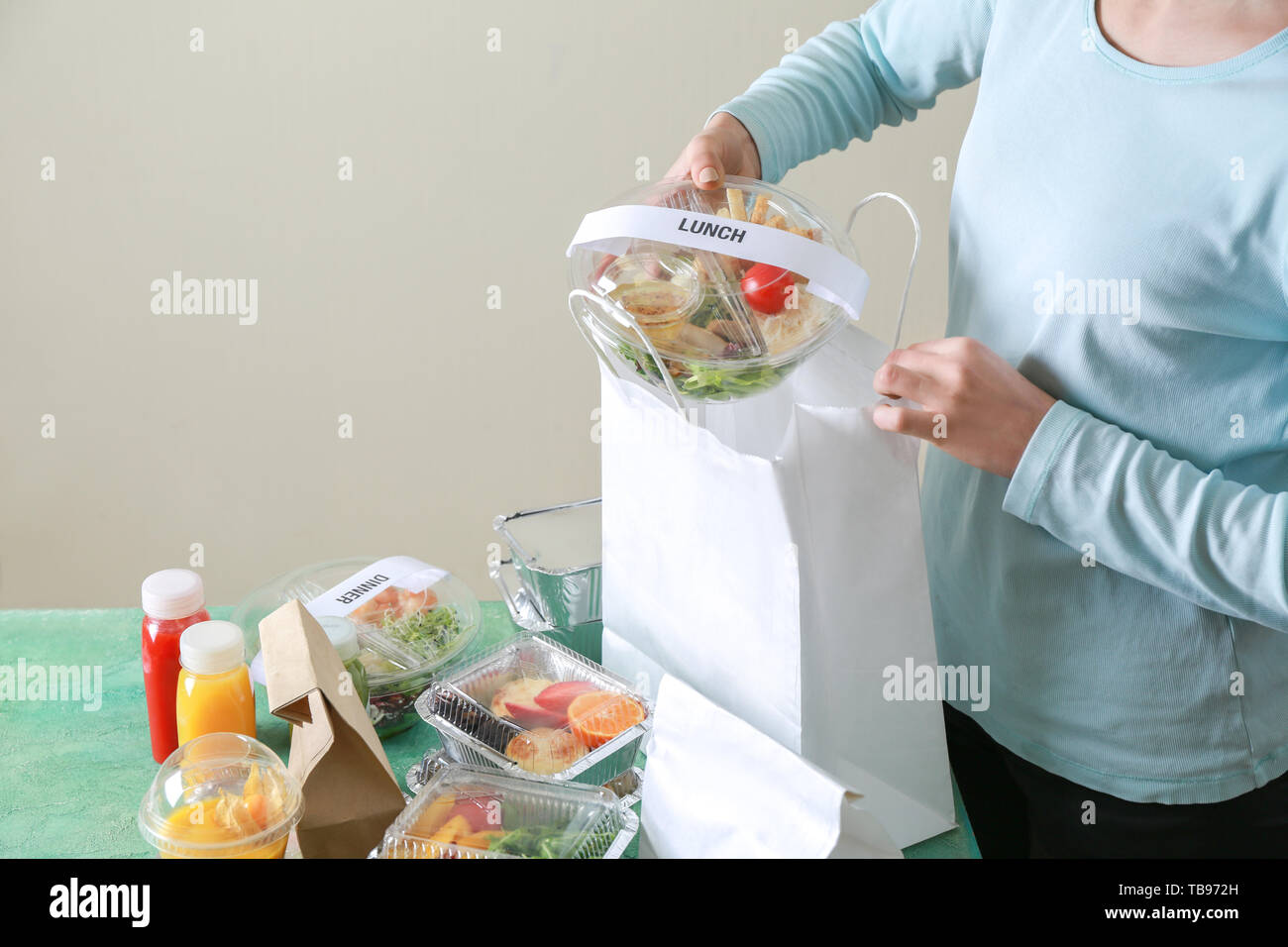 Worker of food delivery service packing order for customer Stock Photo ...