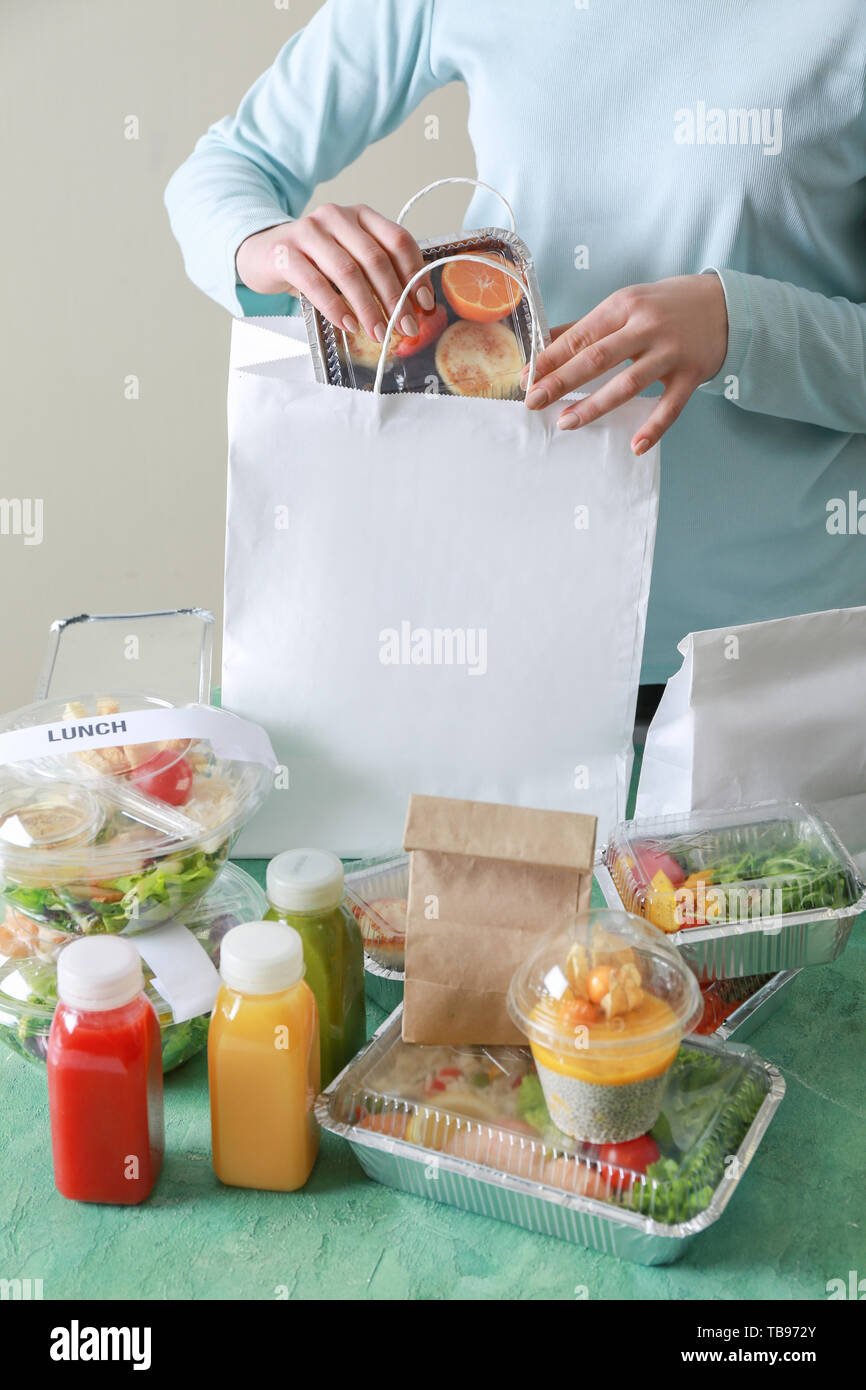 Worker of food delivery service packing order for customer Stock Photo ...