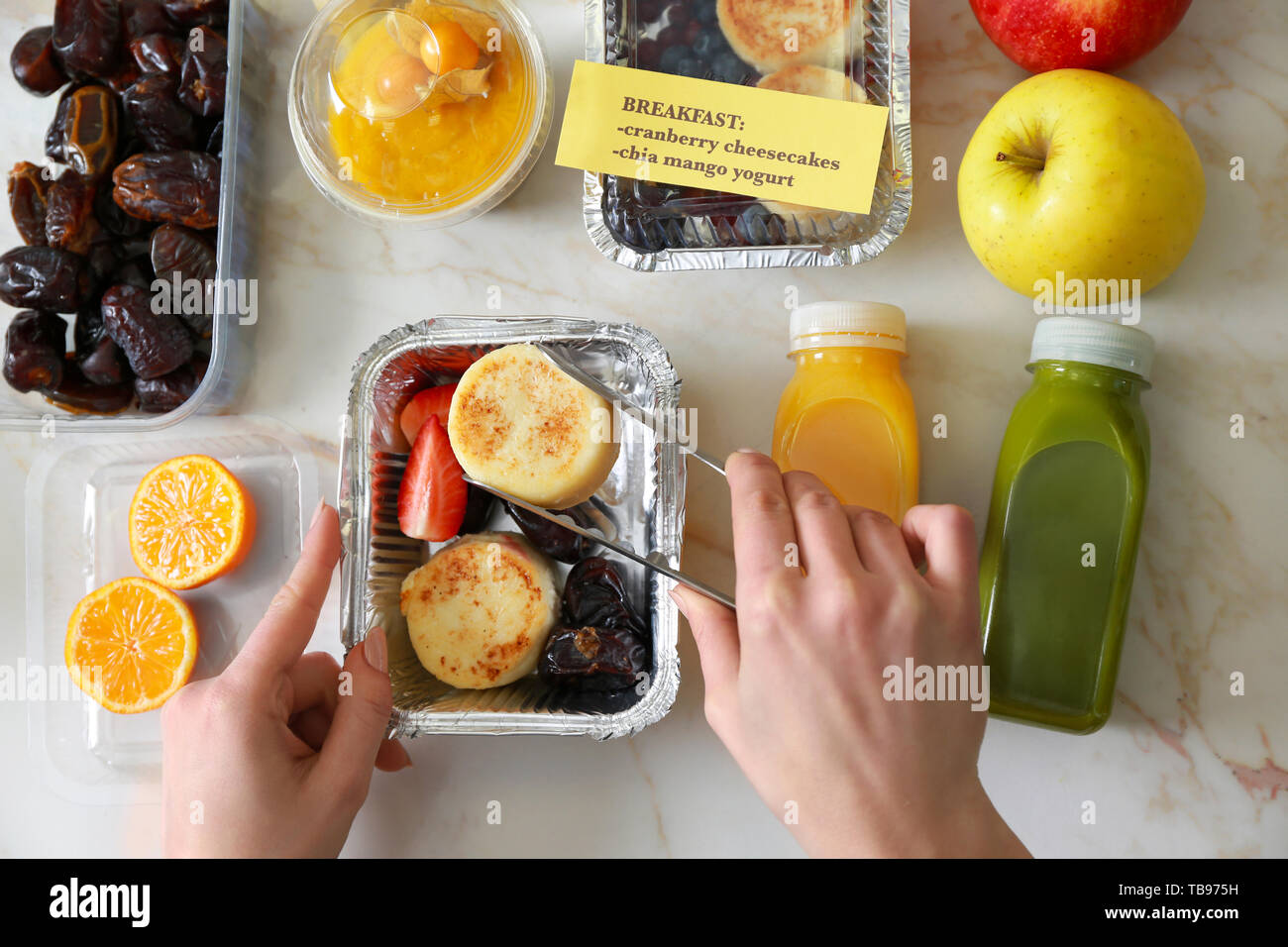 Worker of food delivery service packing order for customer Stock Photo ...