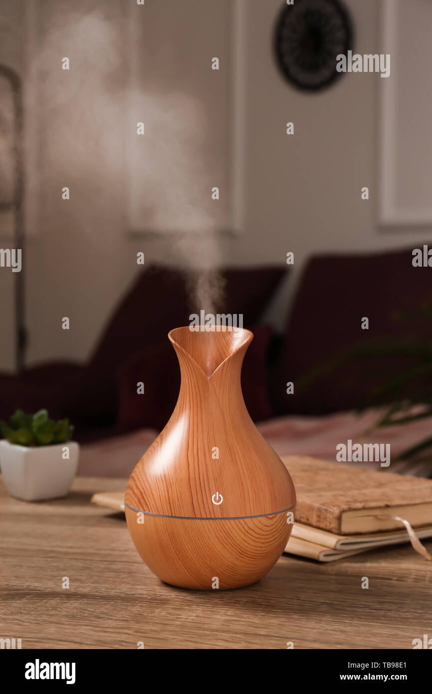 Aroma oil diffuser on table in room Stock Photo - Alamy