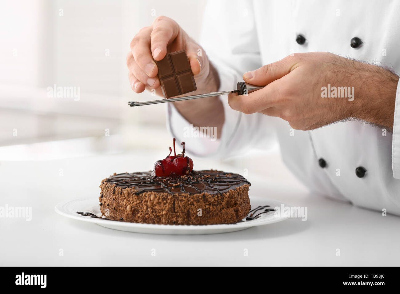 Man decorating cake closeup hi-res stock photography and images - Alamy