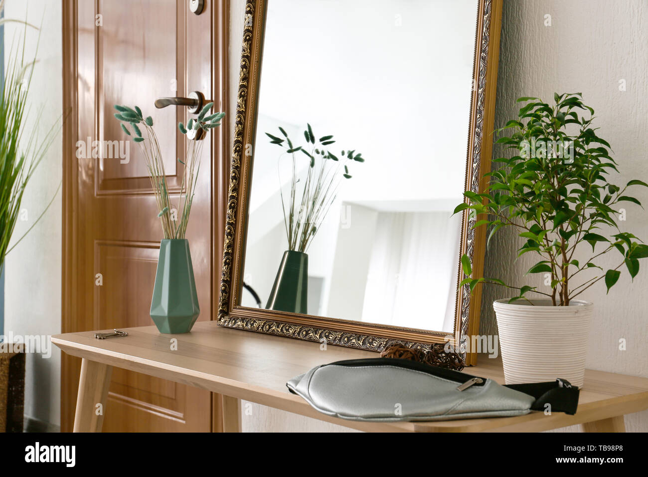 Table with big mirror in interior of hall Stock Photo - Alamy