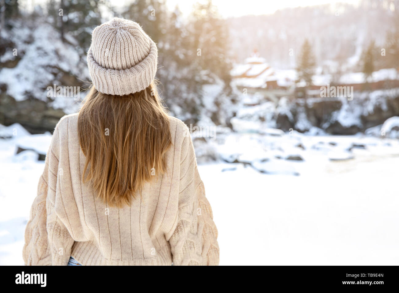 Beautiful woman at snowy resort, back view Stock Photo - Alamy