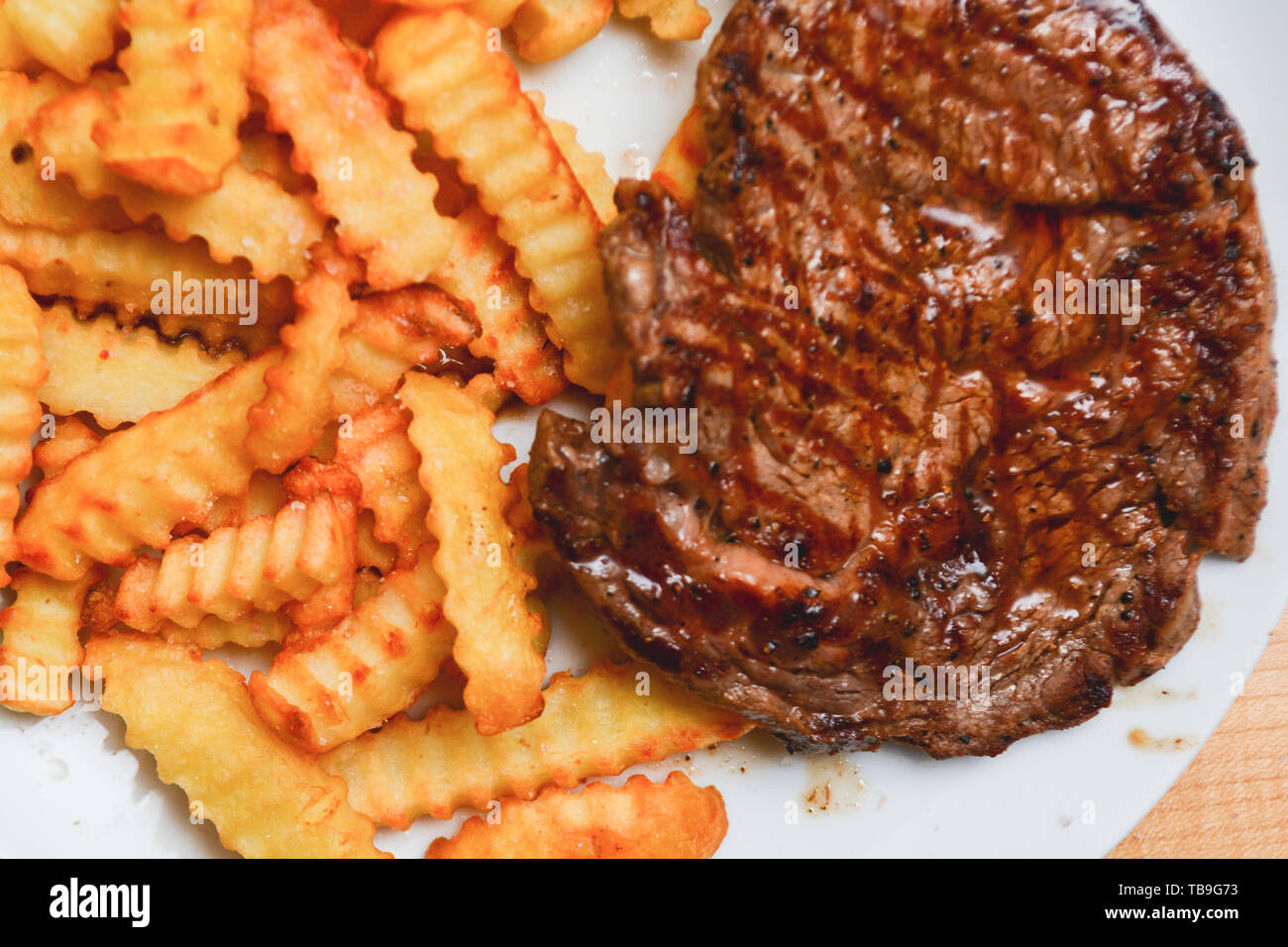Steak and chips, tasty ribeye steak served with fries Stock Photo - Alamy