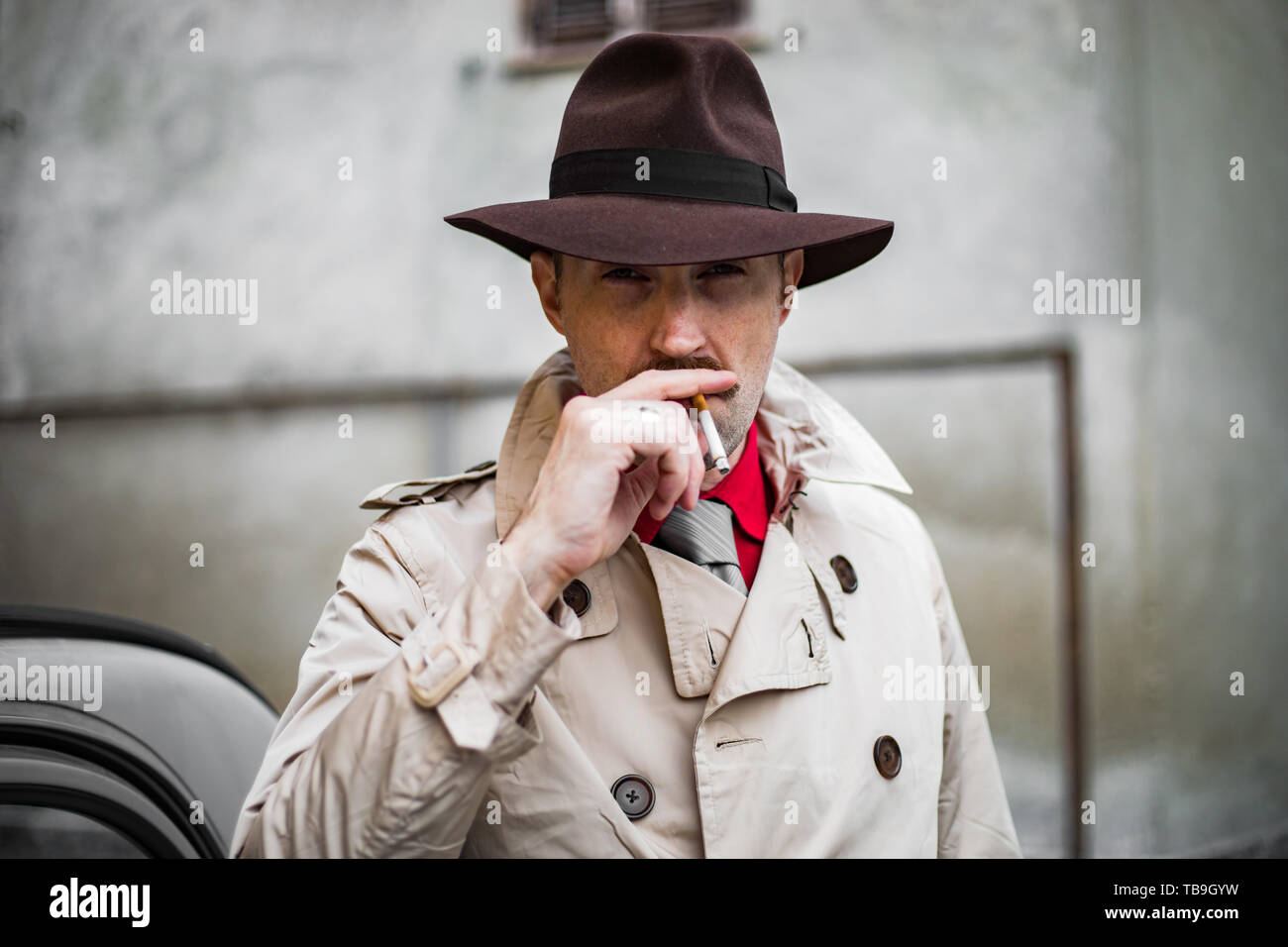 Vintage detective smoking a sigarette ina city slum Stock Photo - Alamy