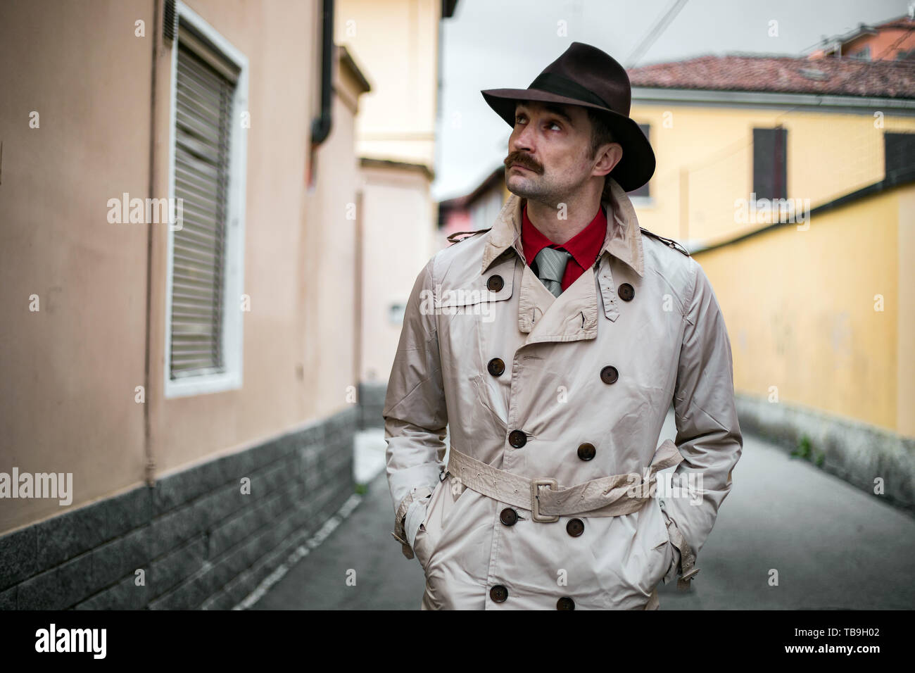 Detective walking in the city slums Stock Photo - Alamy