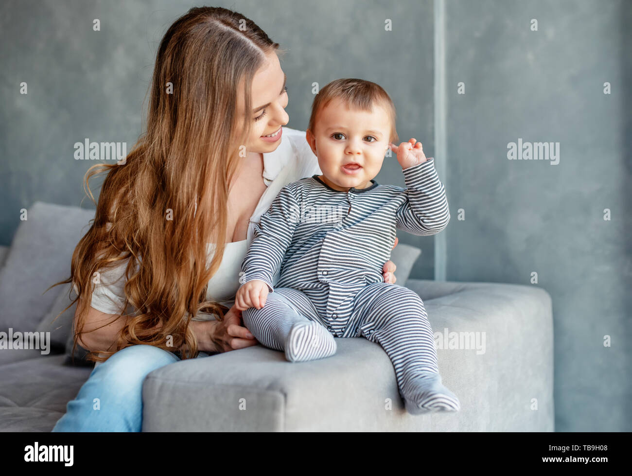 Little child smiling and happy with mom Stock Photo - Alamy