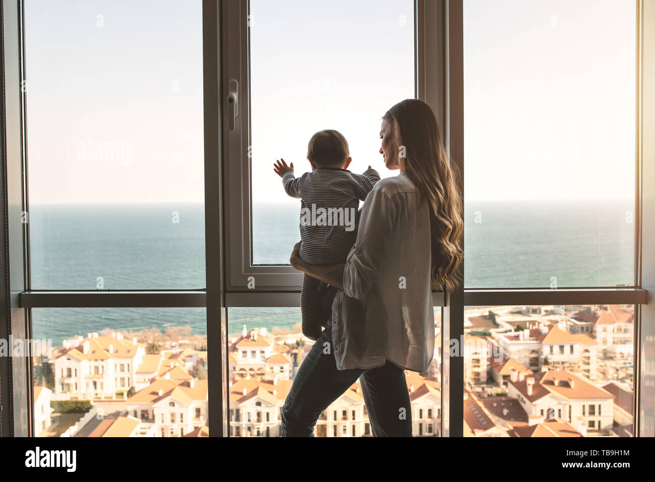 Little child smiling and happy with mom Stock Photo - Alamy