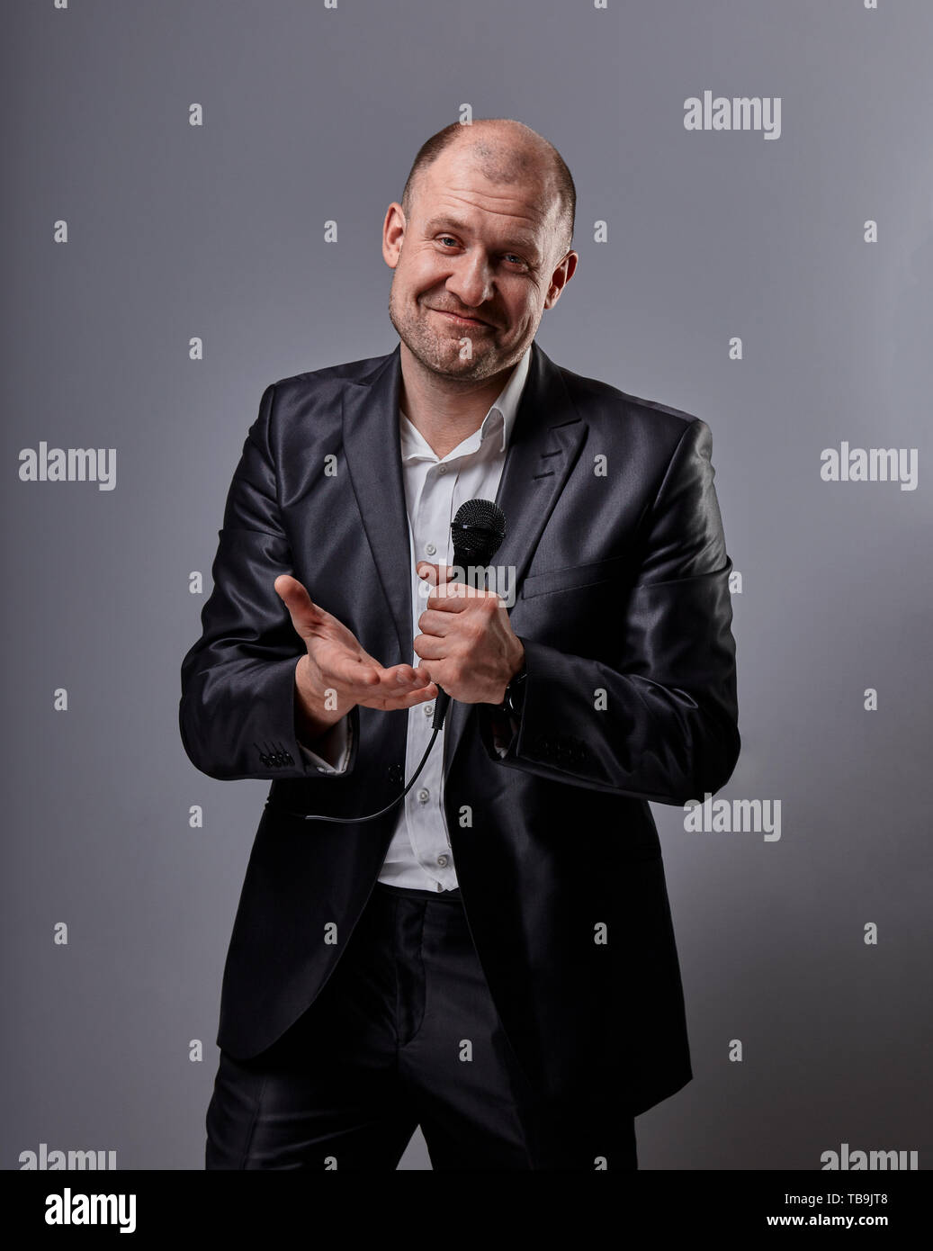 Fun emotional moving happy performer man presenting the show holding ...