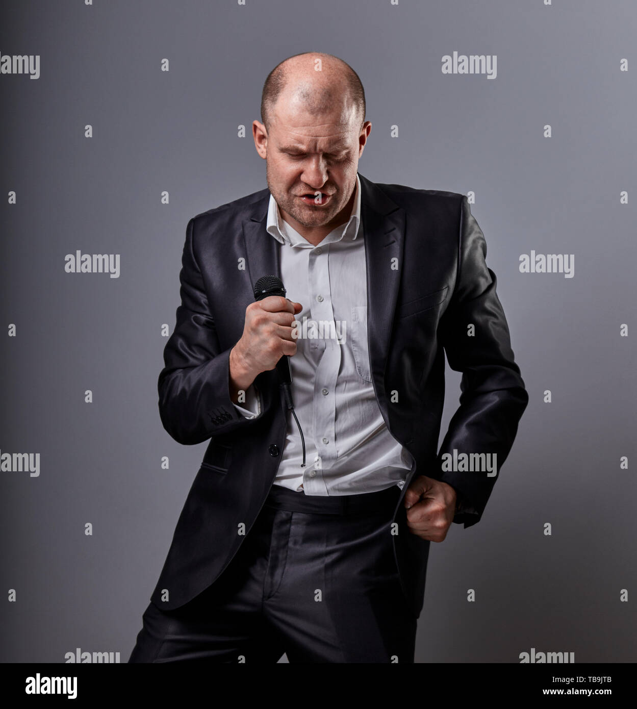 Fun emotional happy performer man presenting the show holding ...