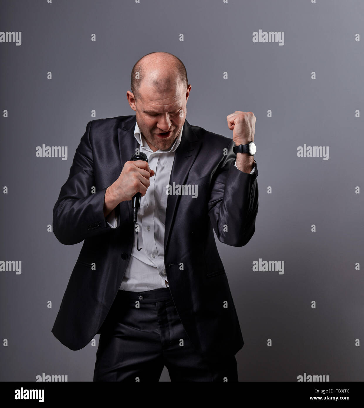 Fun emotional happy performer man presenting the show holding ...