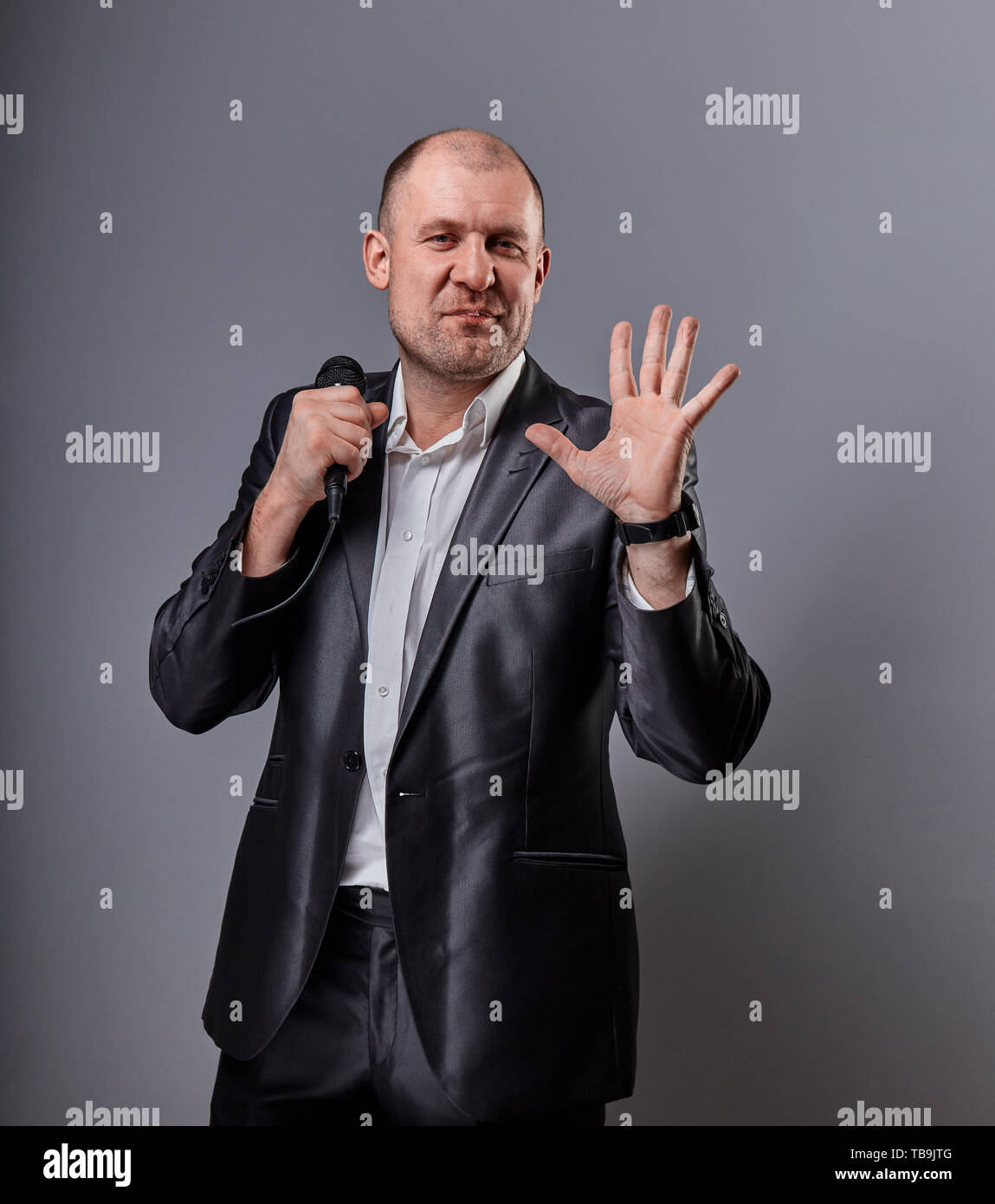 Fun emotional moving happy performer man presenting the show holding ...