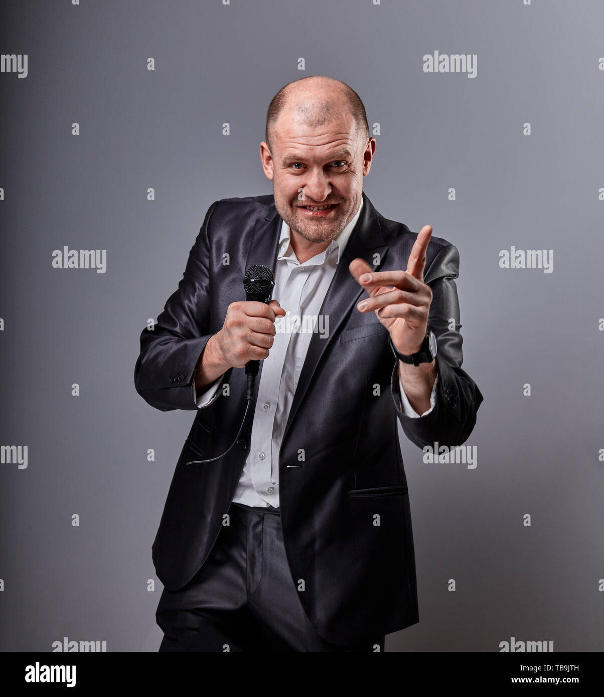 Fun emotional moving happy performer man presenting the show holding ...