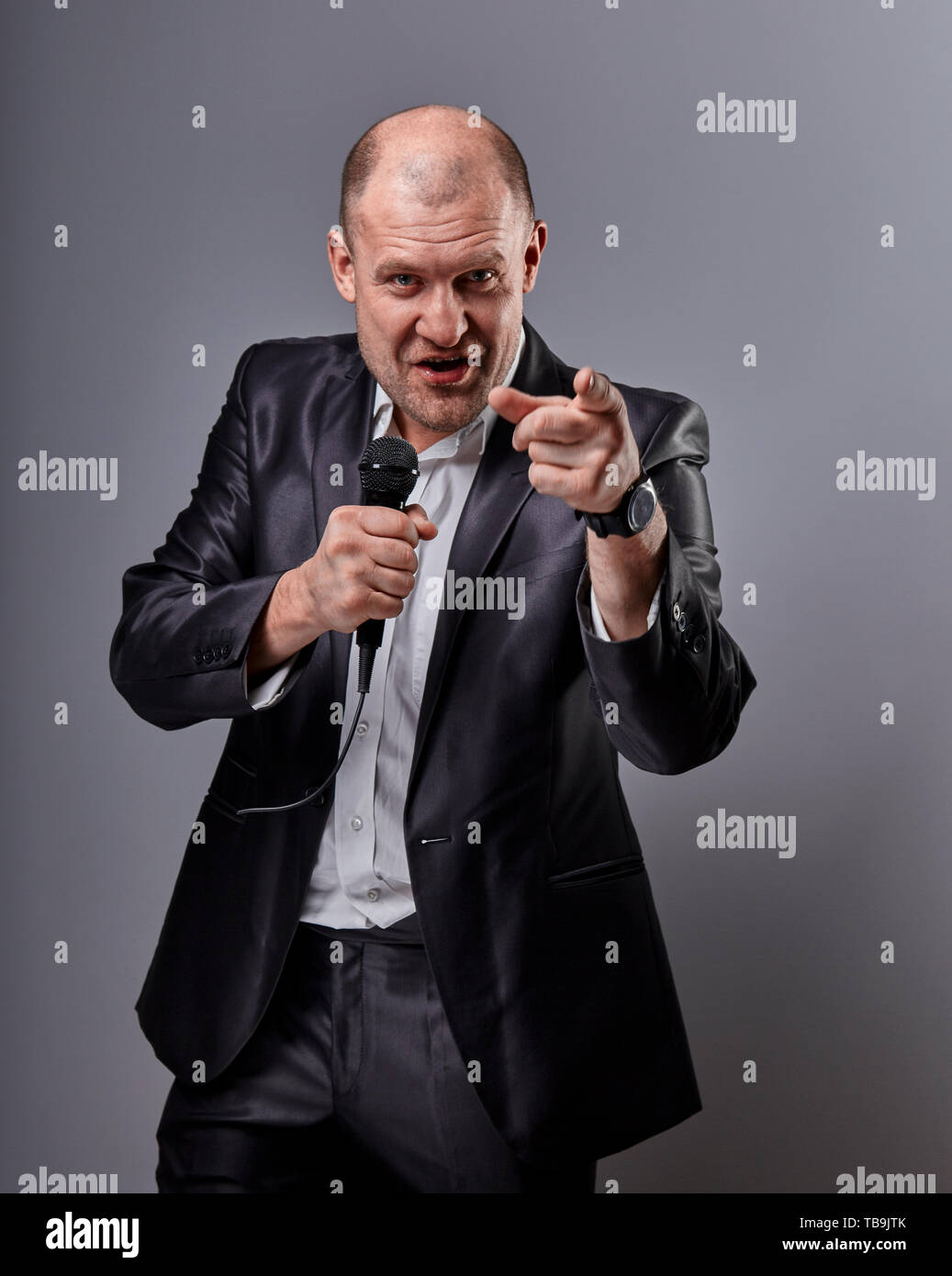 Fun emotional moving happy performer man presenting the show holding ...