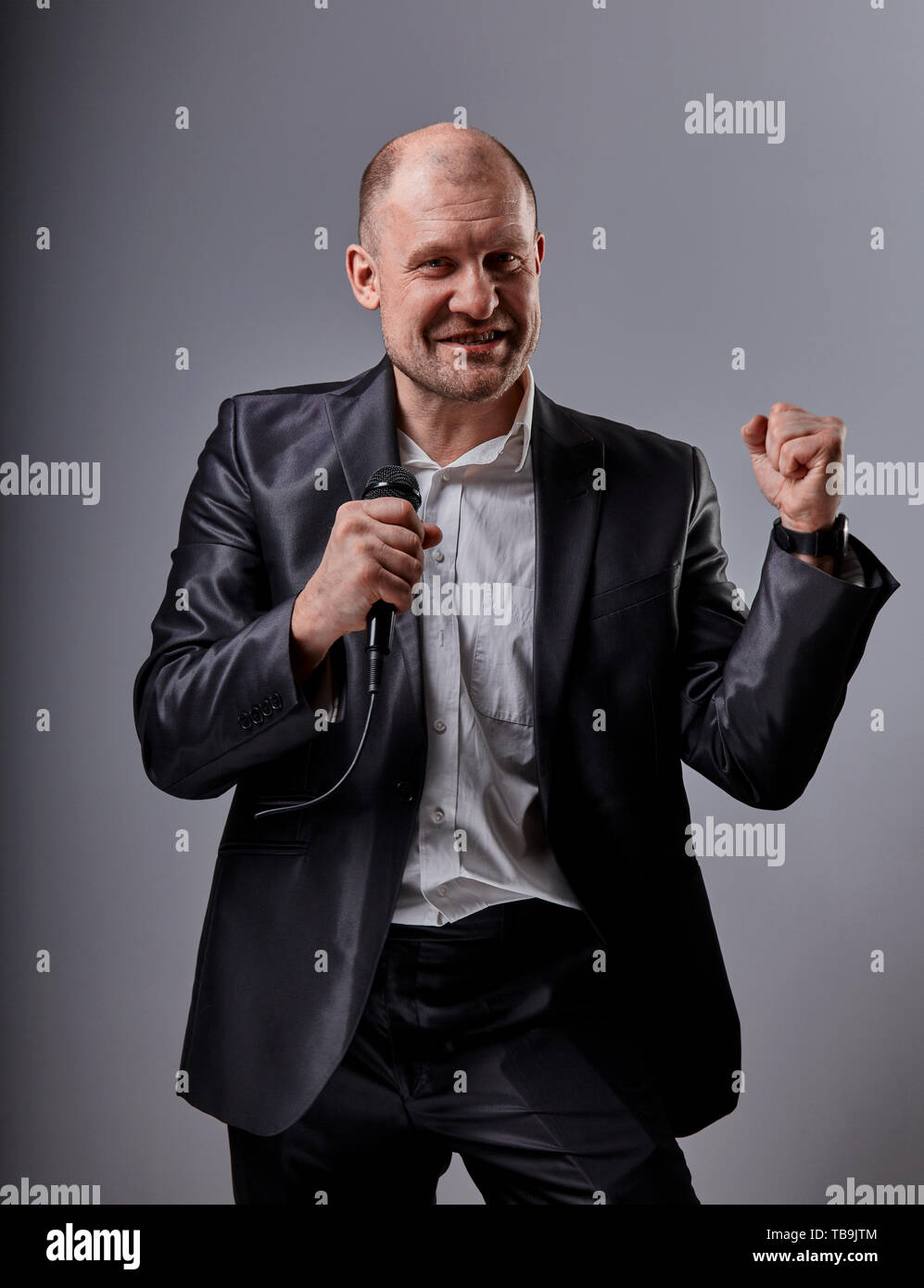 Fun emotional happy performer man presenting the show holding ...