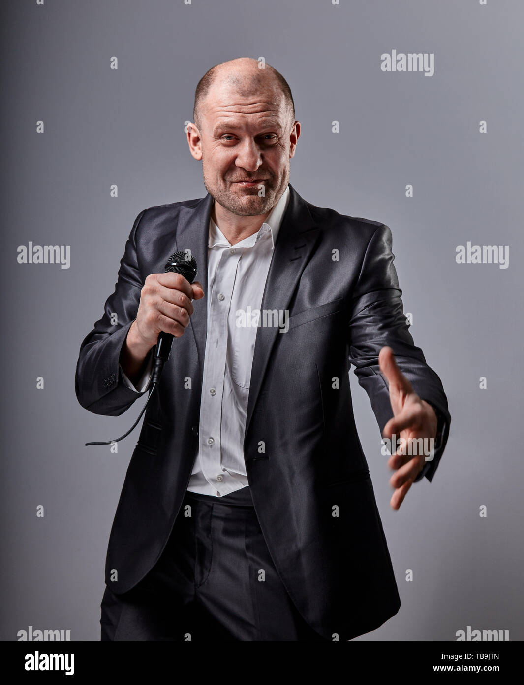 Fun emotional moving happy performer man presenting the show holding ...