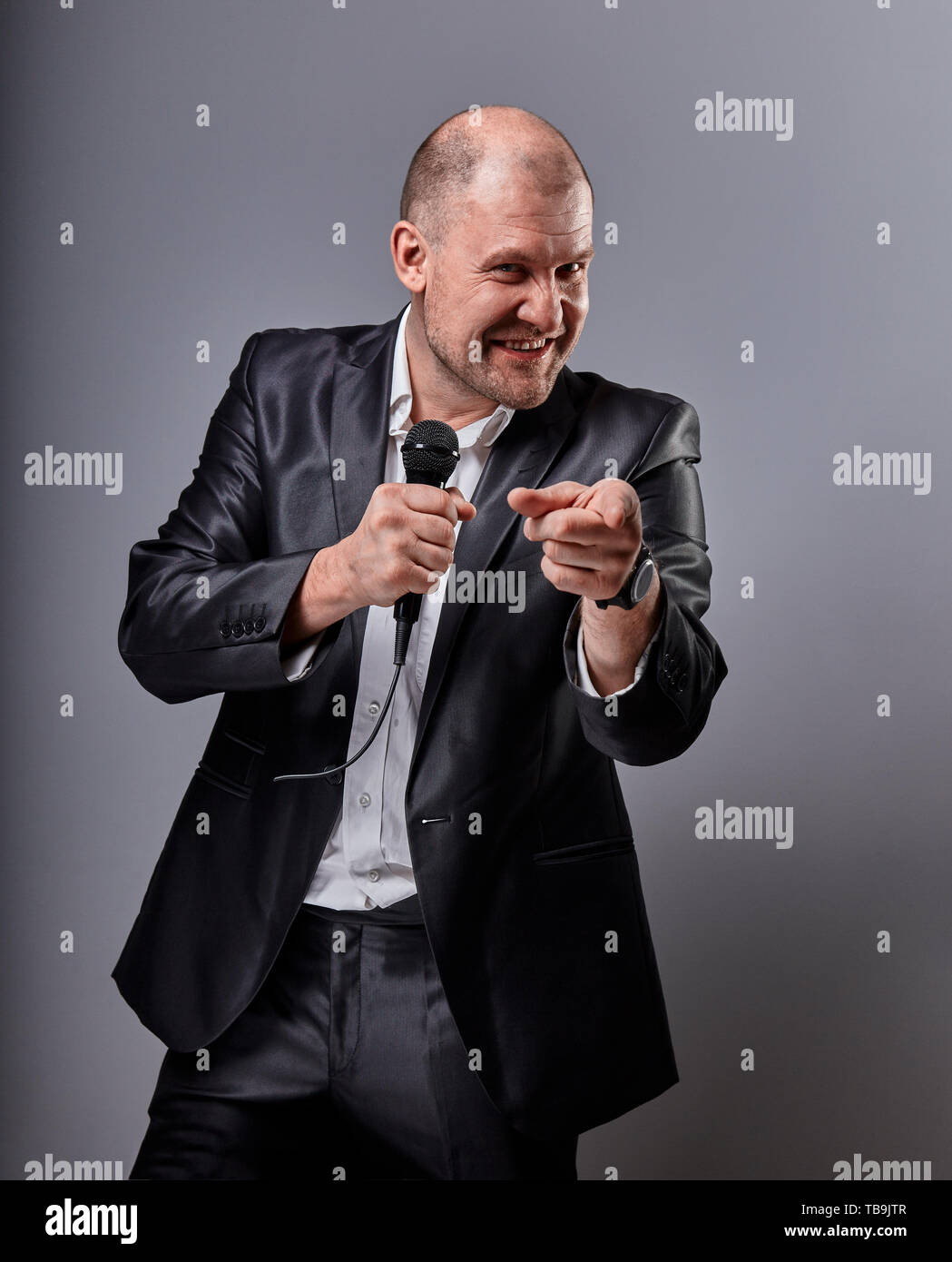 Fun emotional moving happy performer man presenting the show holding ...