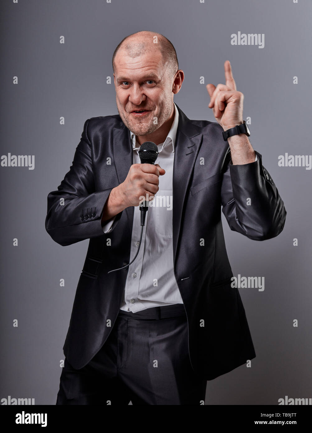 Fun emotional moving happy performer man presenting the show holding ...