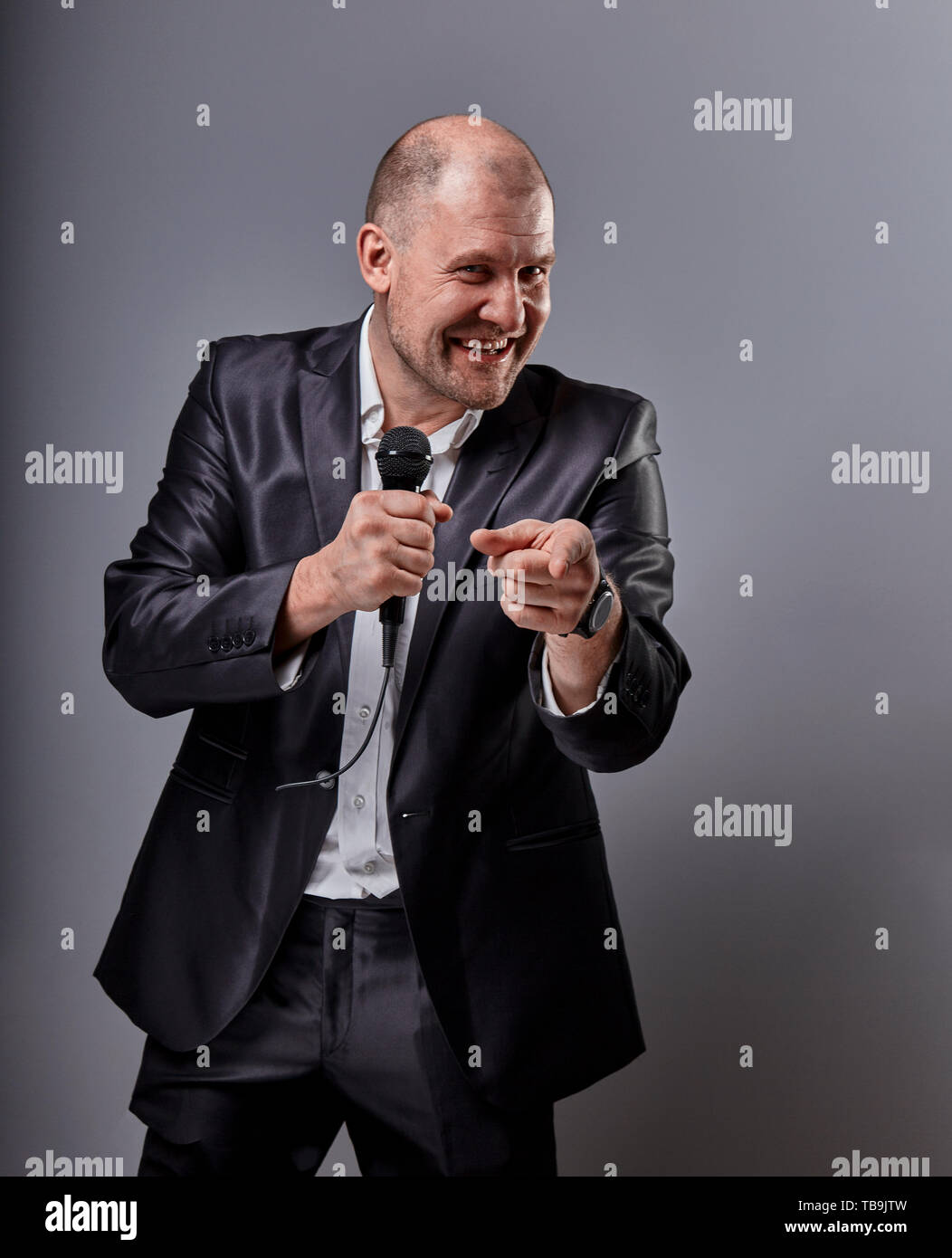 Fun emotional moving happy performer man presenting the show holding ...