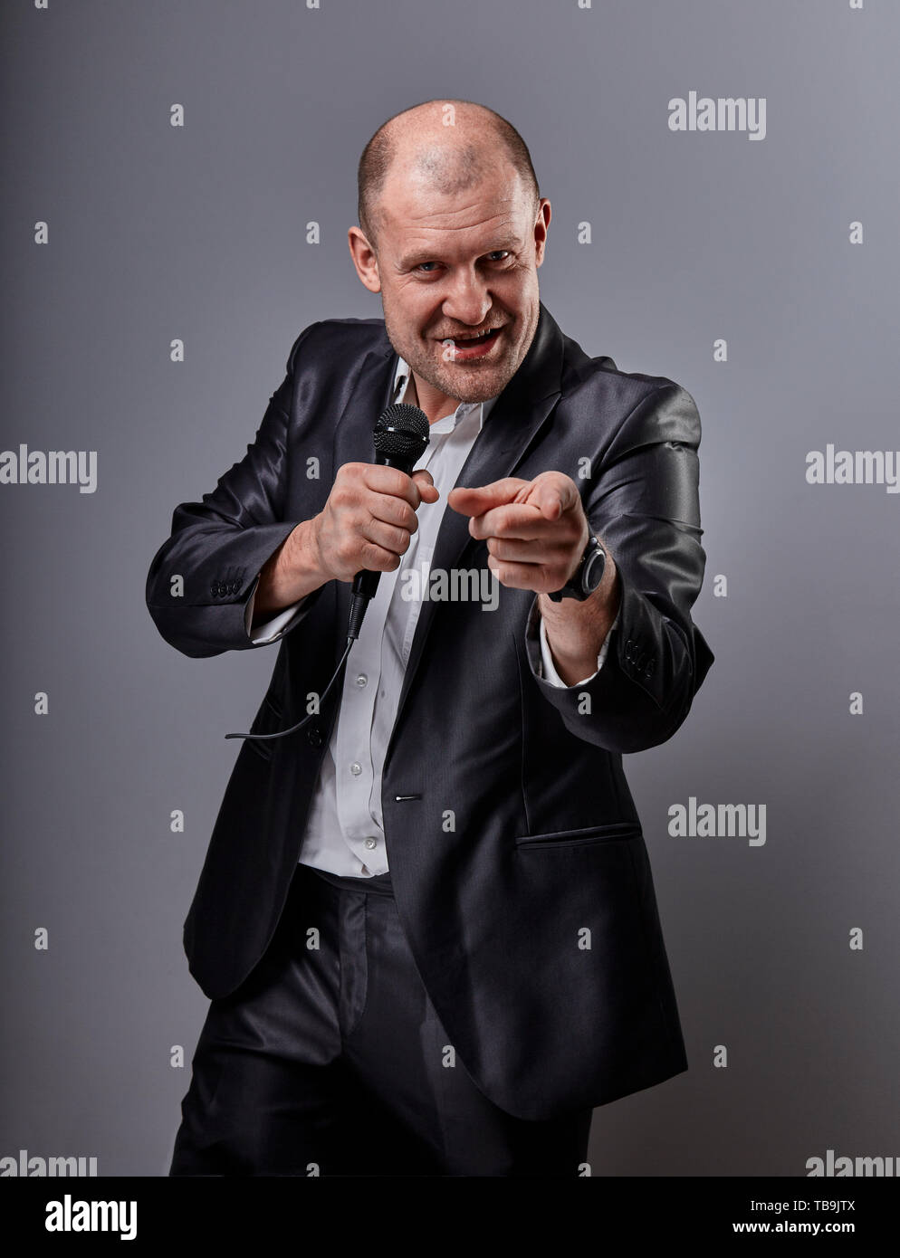 Fun emotional moving happy performer man presenting the show holding ...