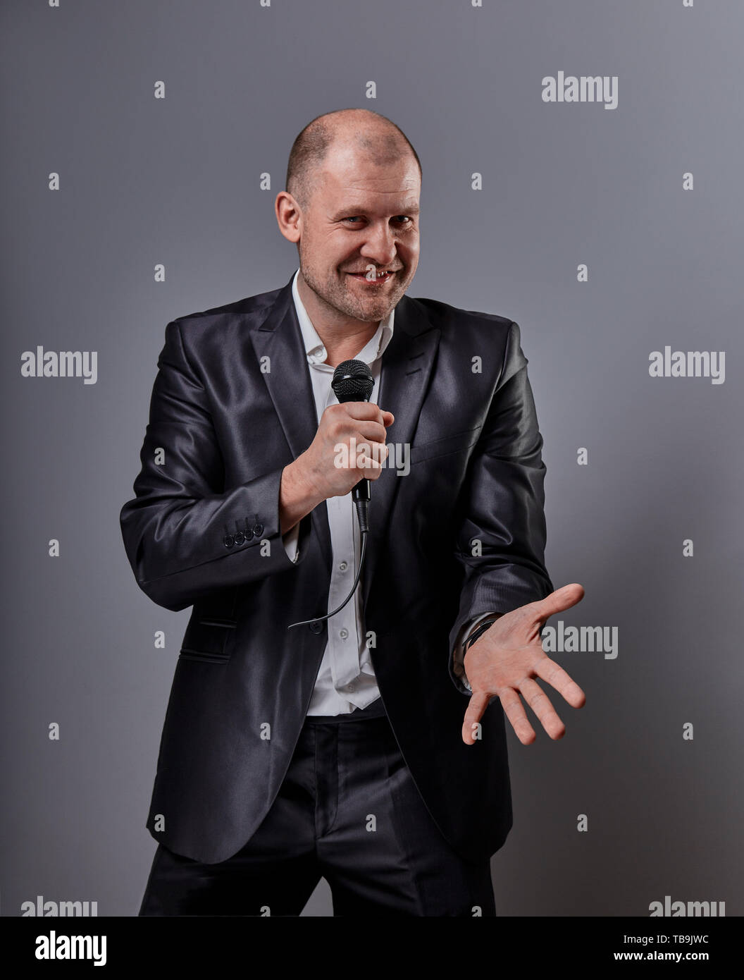 Fun emotional moving happy performer man presenting the show holding ...