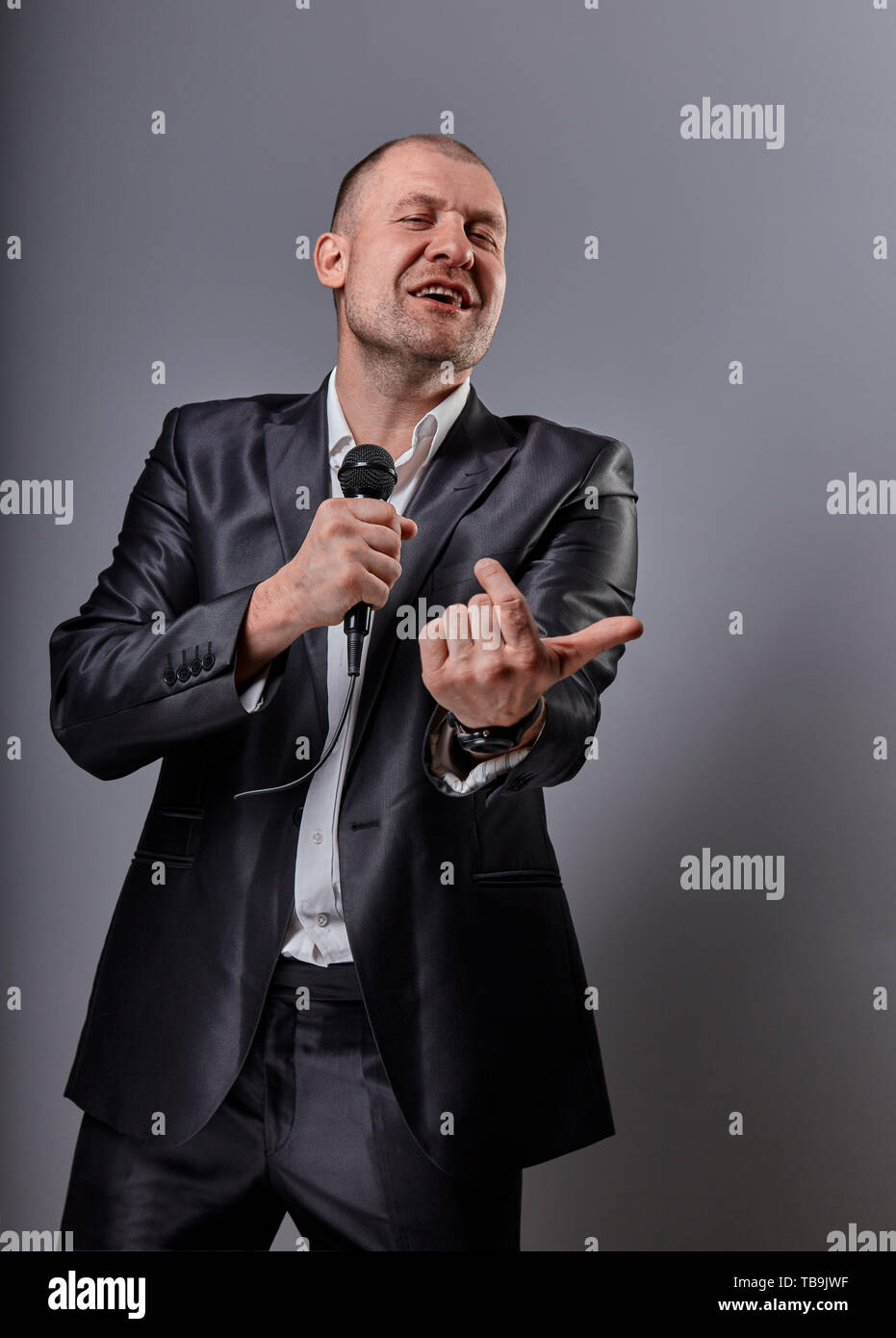 Smiling emotional happy performer man presenting the show holding ...