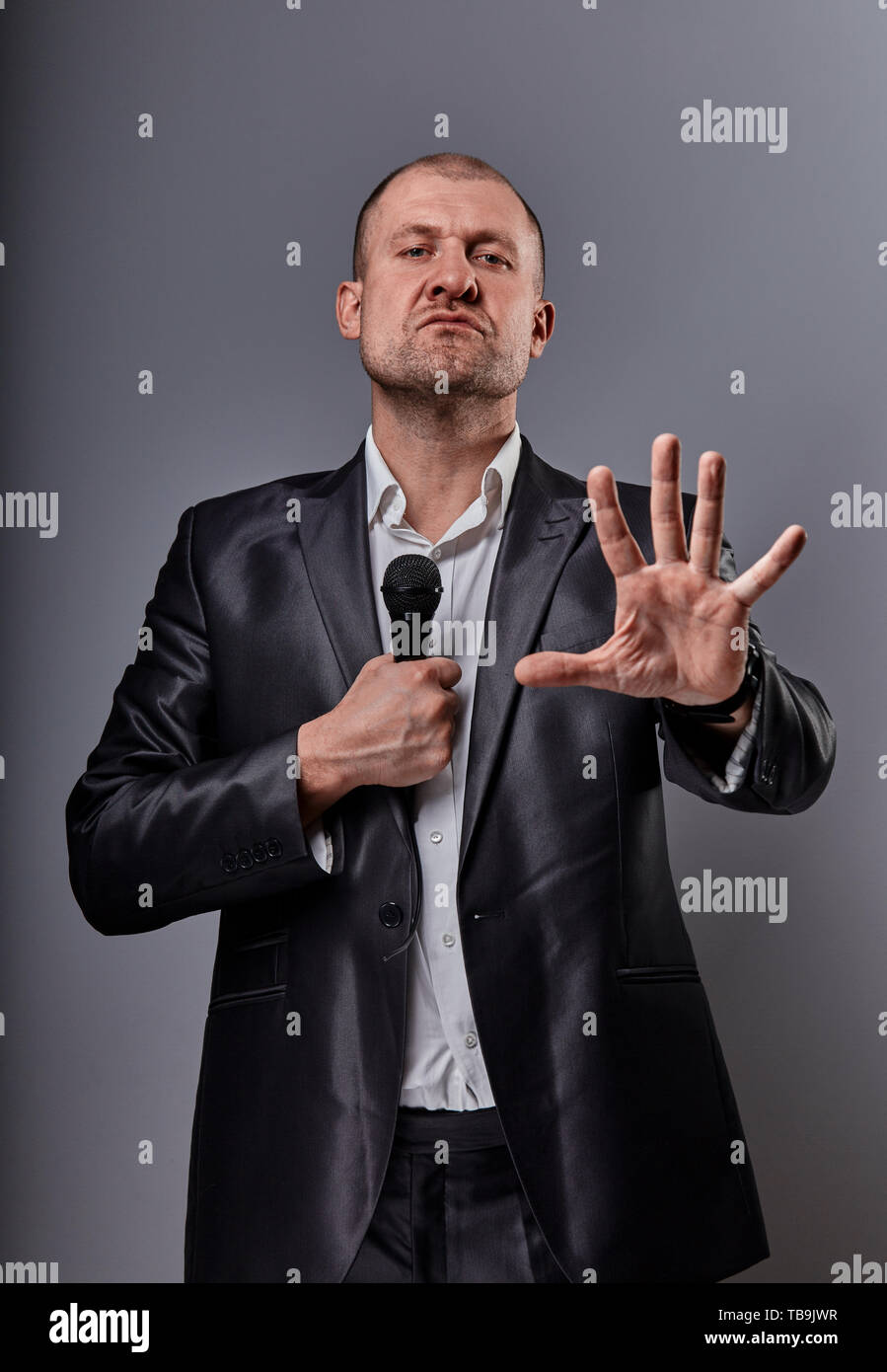 Fun emotional moving happy performer man presenting the show holding ...