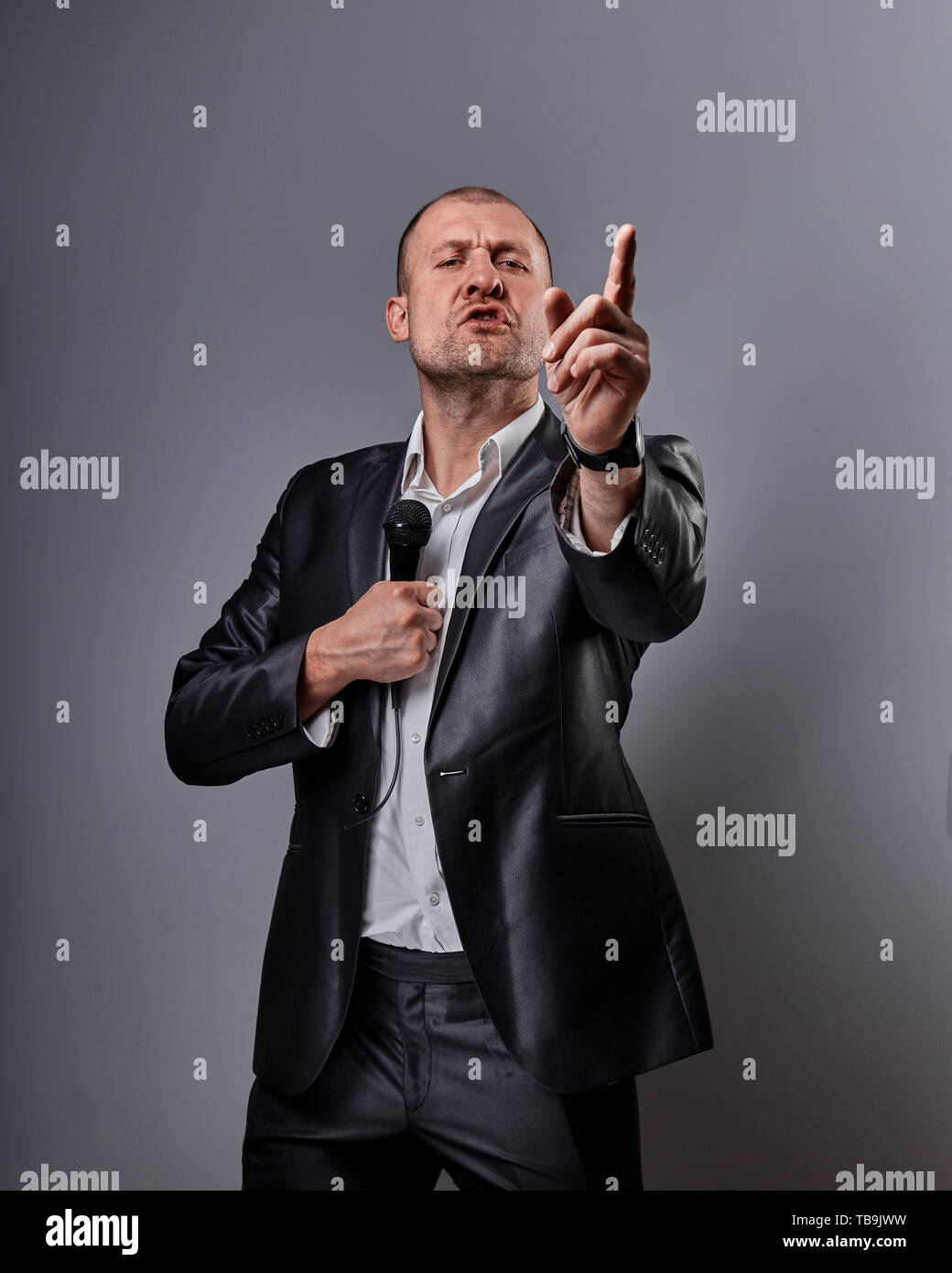 Fun emotional moving happy performer man presenting the show holding ...