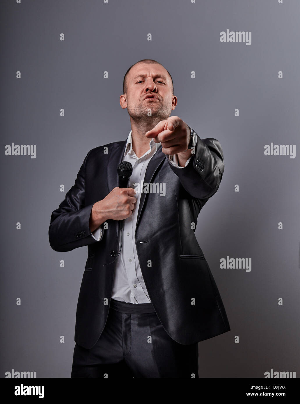 Fun emotional moving happy performer man presenting the show holding ...